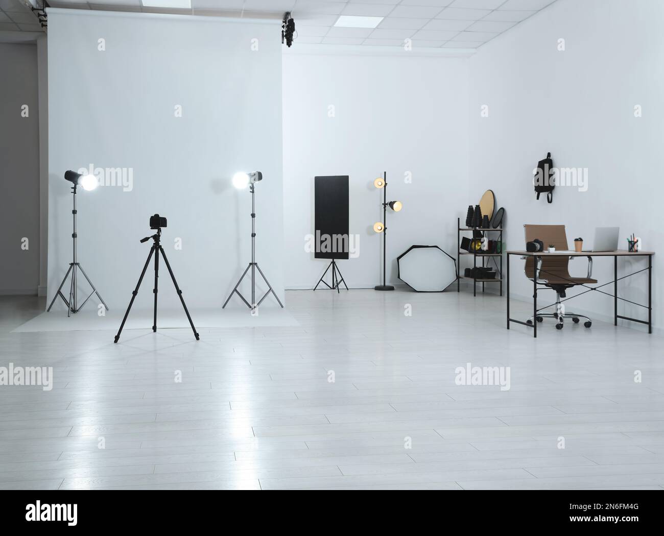 Photo studio interior with set of professional equipment and workplace ...
