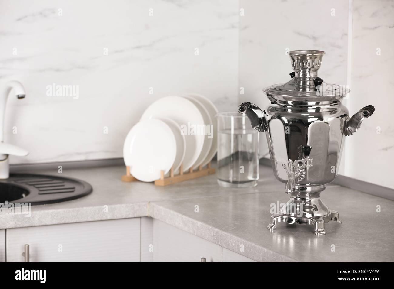 Metal samovar on grey countertop in kitchen. Russian tea culture Stock ...