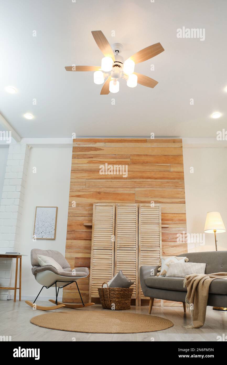 Stylish living room interior with modern ceiling fan and comfortable ...