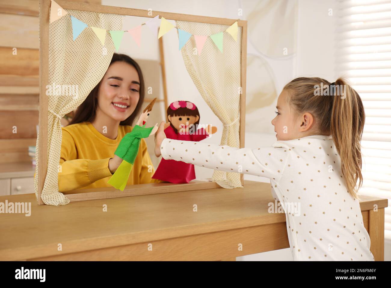 Mother performing puppet show for her daughter at home Stock Photo - Alamy