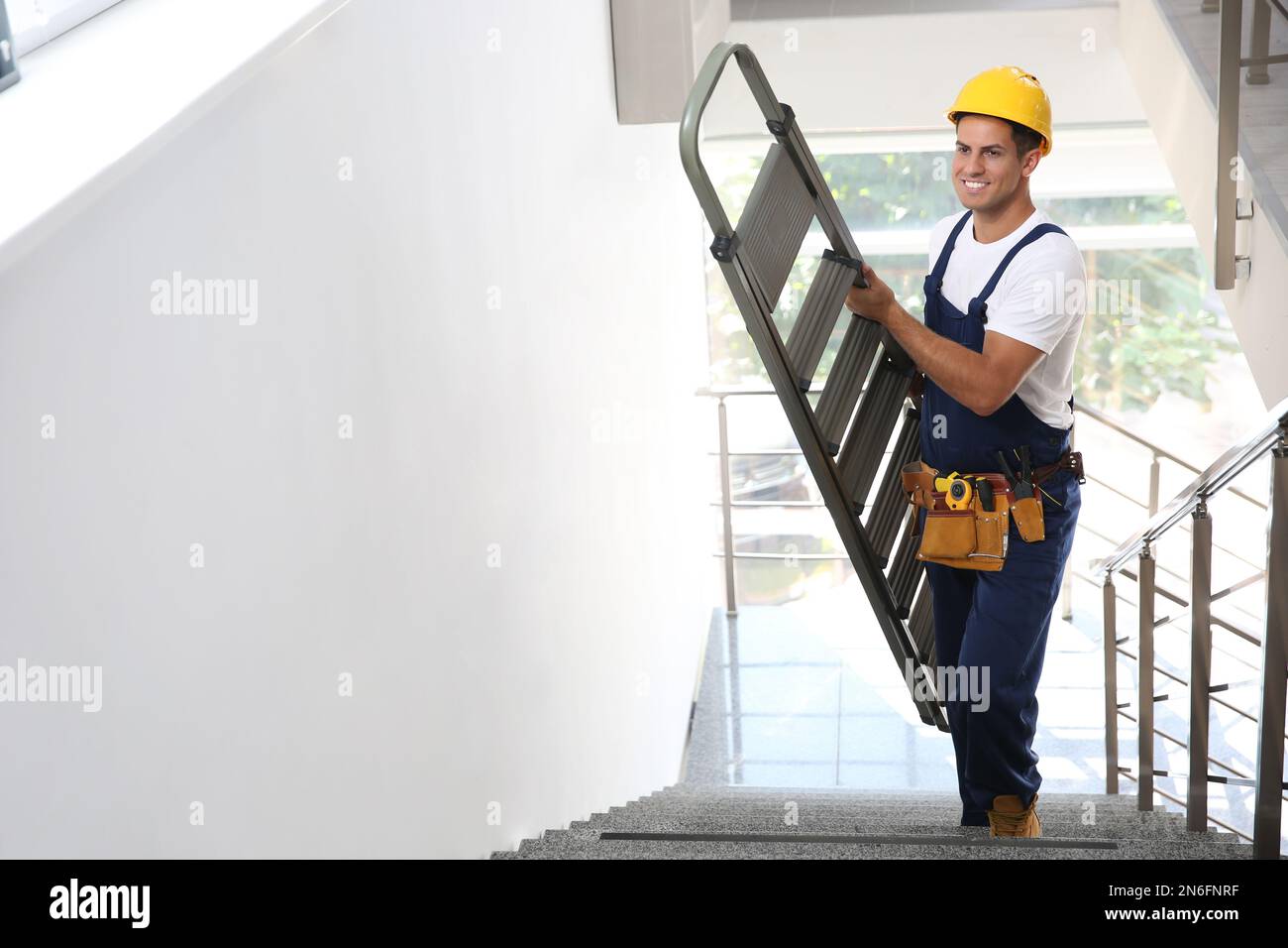 Male worker carrying stepladder hi-res stock photography and images - Alamy