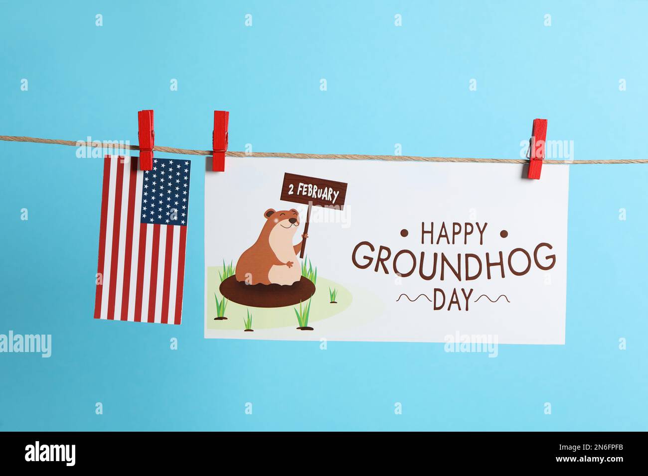 Happy Groundhog Day greeting card and American flag hanging on light ...