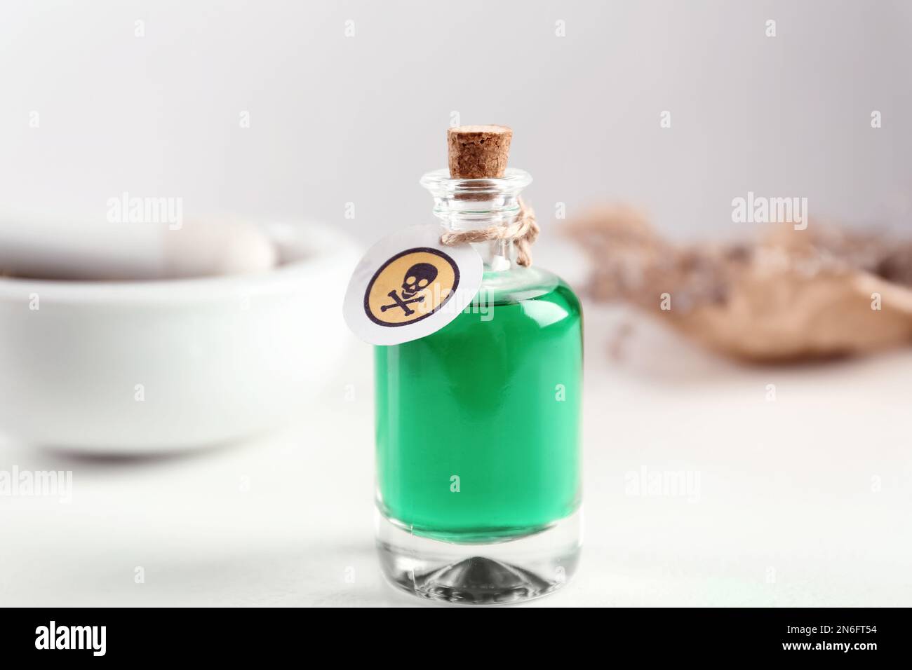 Glass bottle of poison with warning sign on light background Stock ...