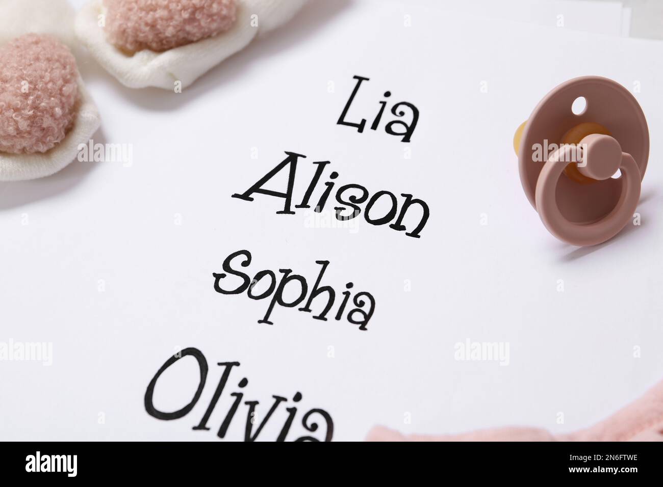 List of baby names and child's accessories, closeup Stock Photo - Alamy