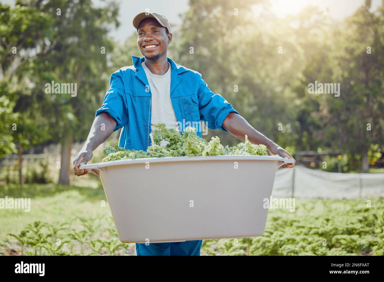 Busy day out on the farm. a handsome young farmer standing alone and ...