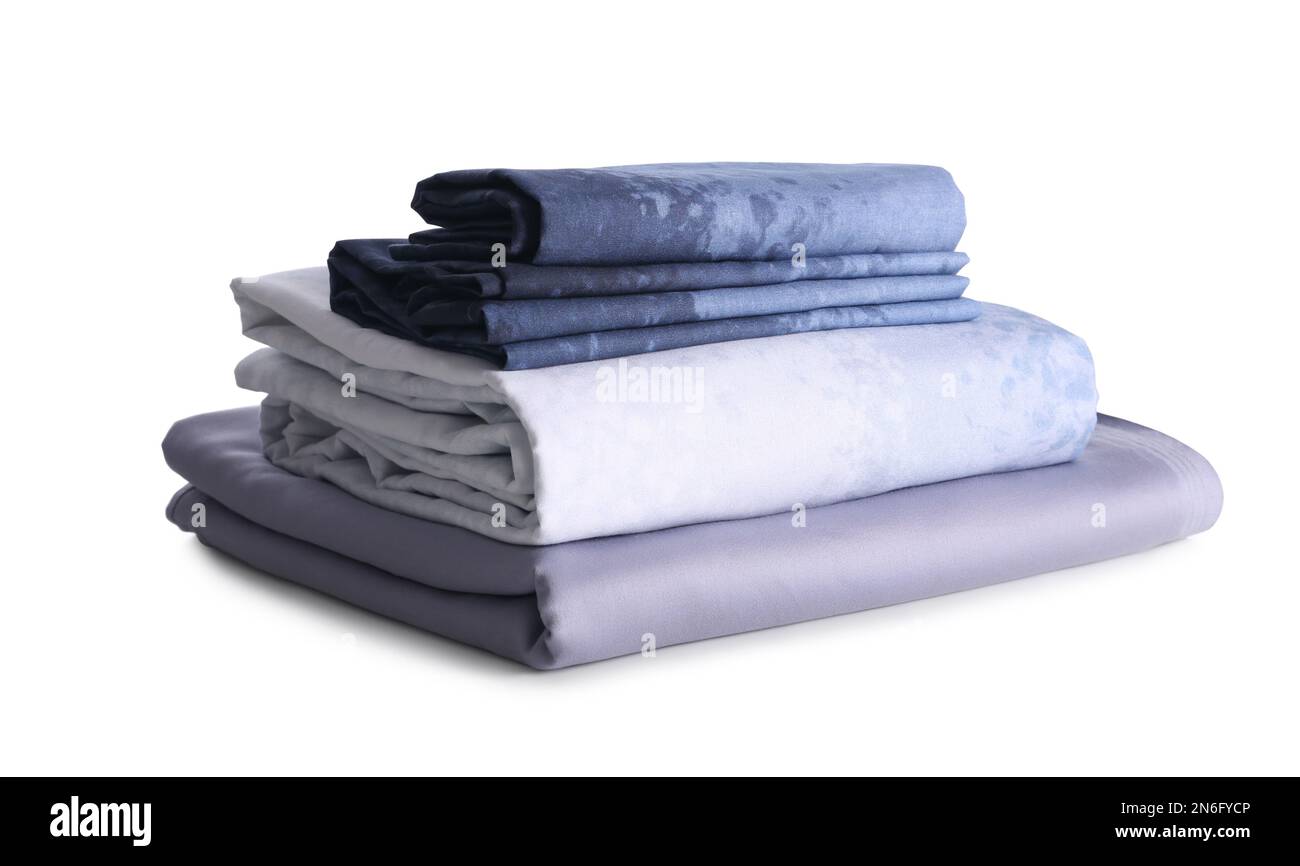 Stack of clean bed linen isolated on white Stock Photo - Alamy