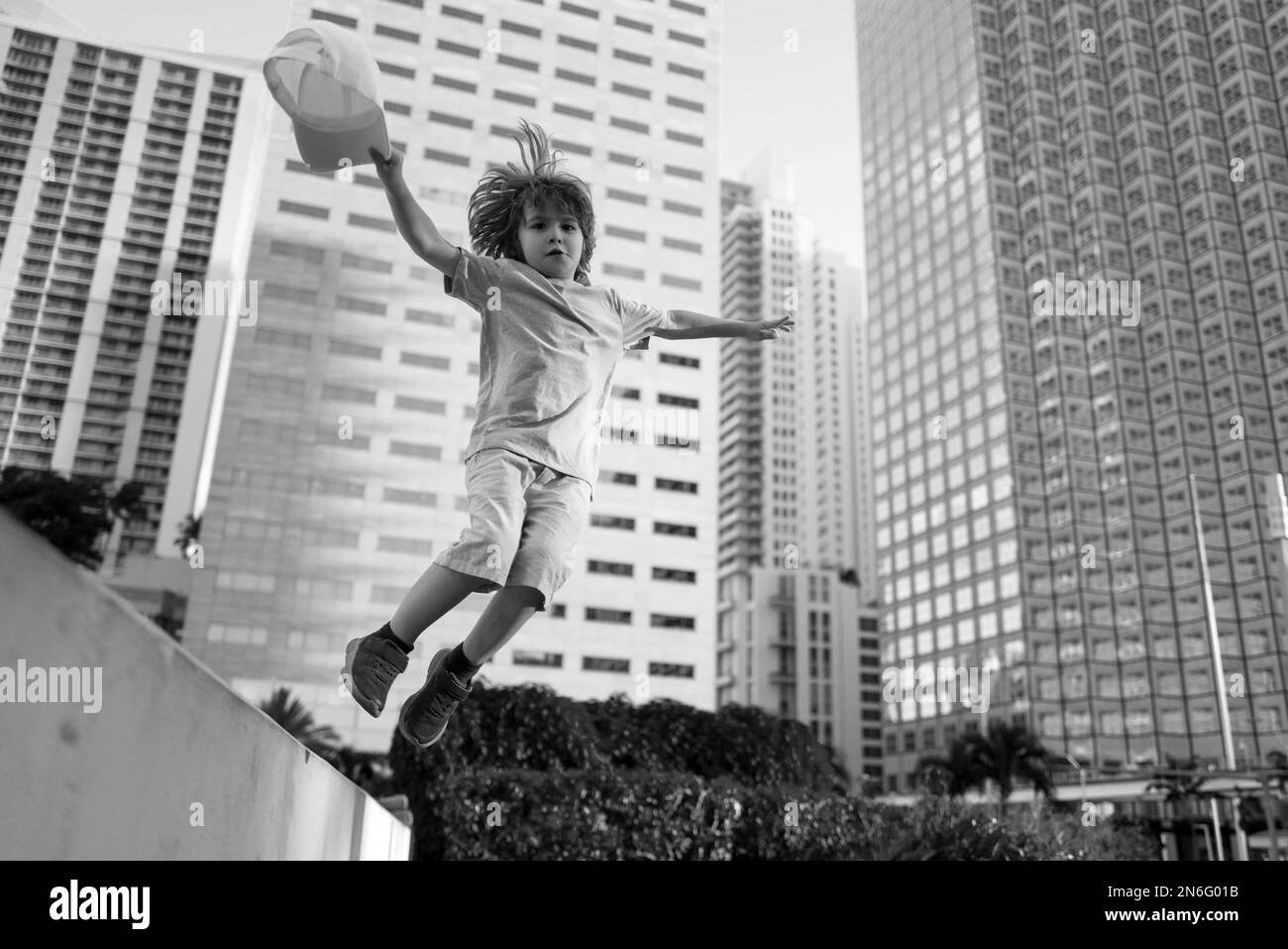 Child fun outdoor. Little boy jump on city street Stock Photo - Alamy