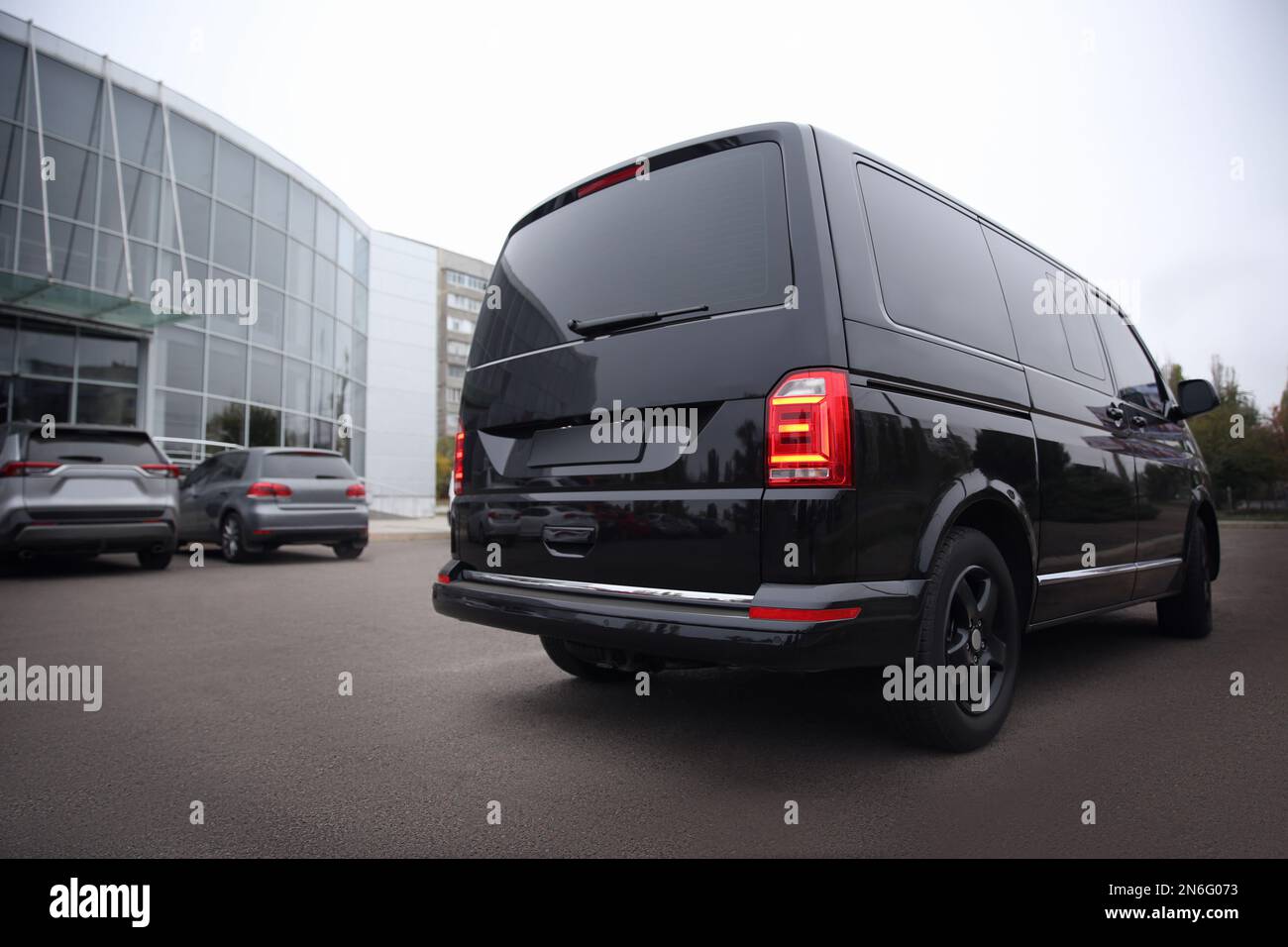 Black delivery van parked on street near building Stock Photo - Alamy