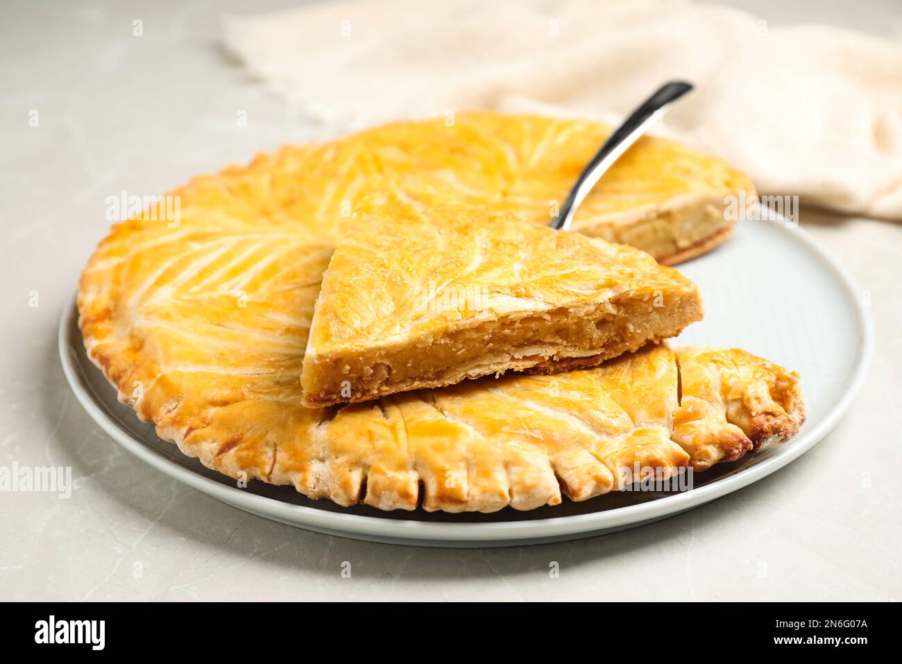 Traditional galette des rois on light grey marble table, closeup Stock ...