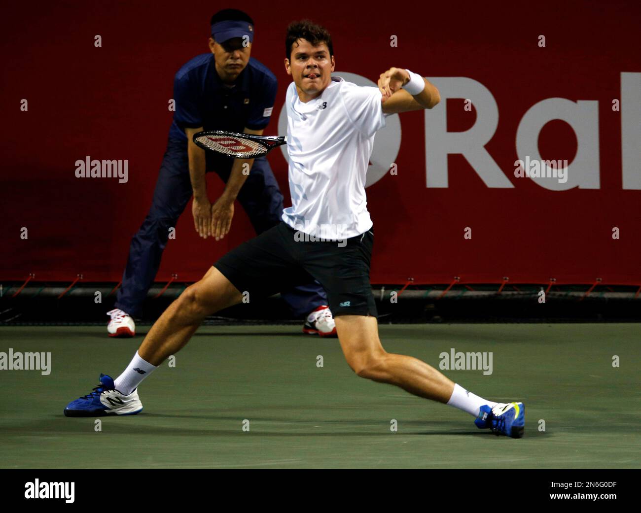 Milos Raonic of Canada watches his return to Go Soeda of Japan during ...