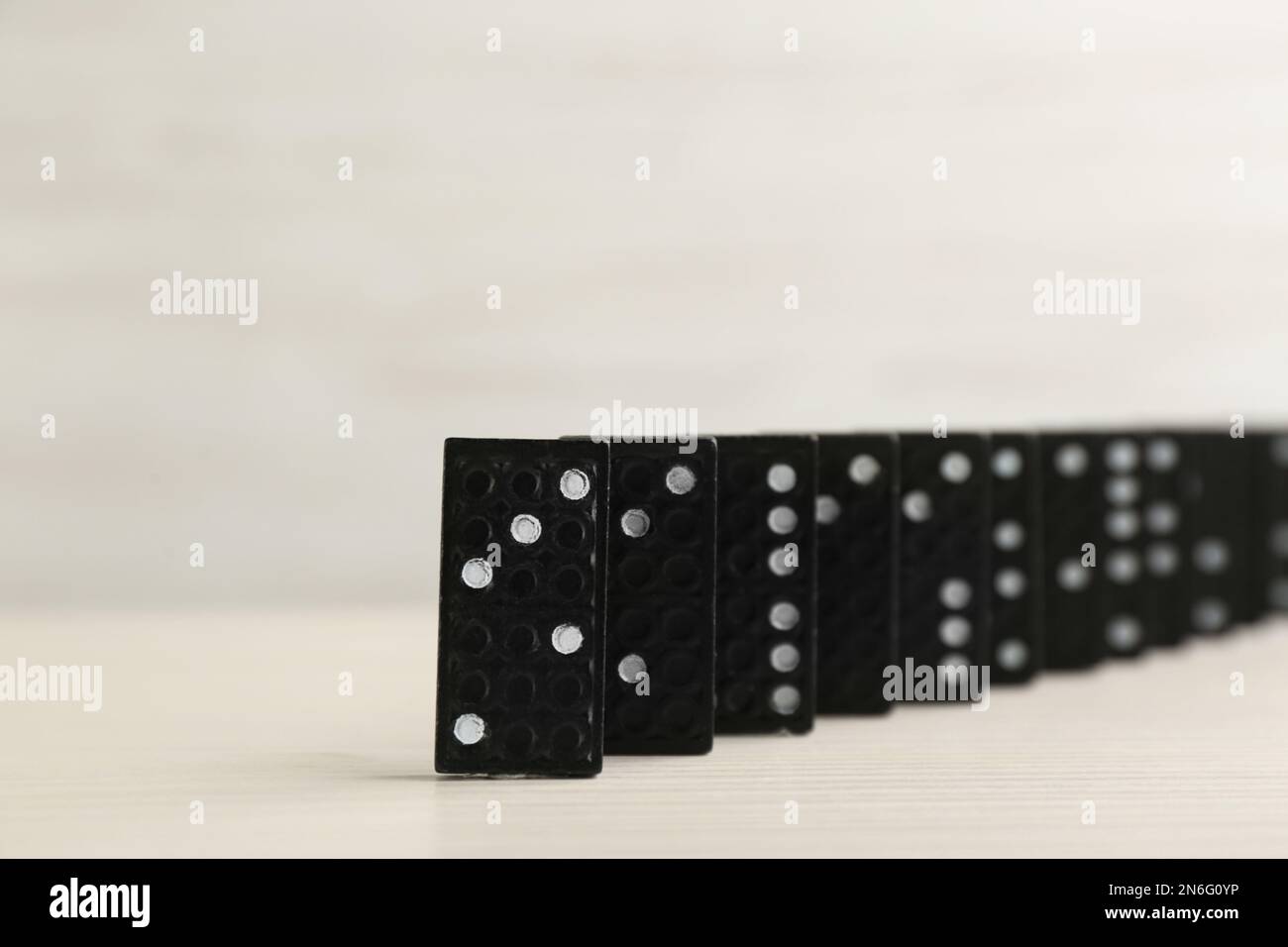 Black domino tiles with pips on white table Stock Photo - Alamy