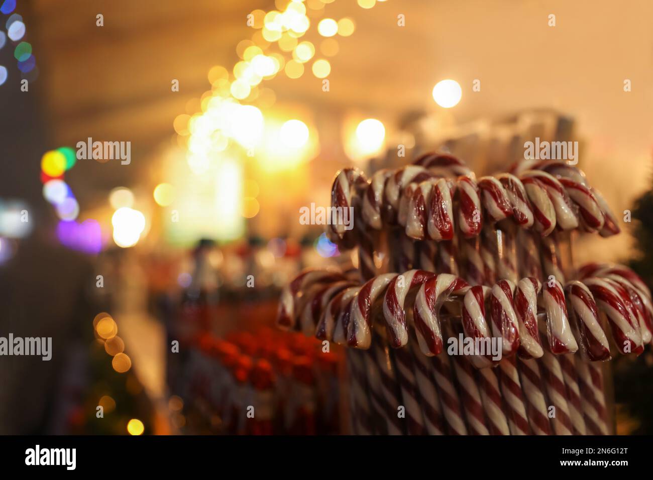 Candy canes on Christmas fair stall display, closeup. Space for text ...