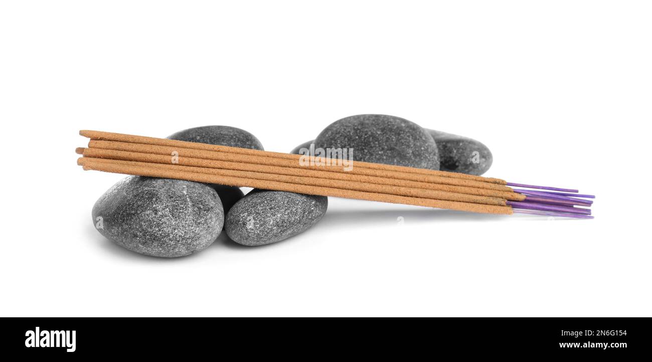 Aromatic incense sticks and spa stones on white background Stock Photo ...