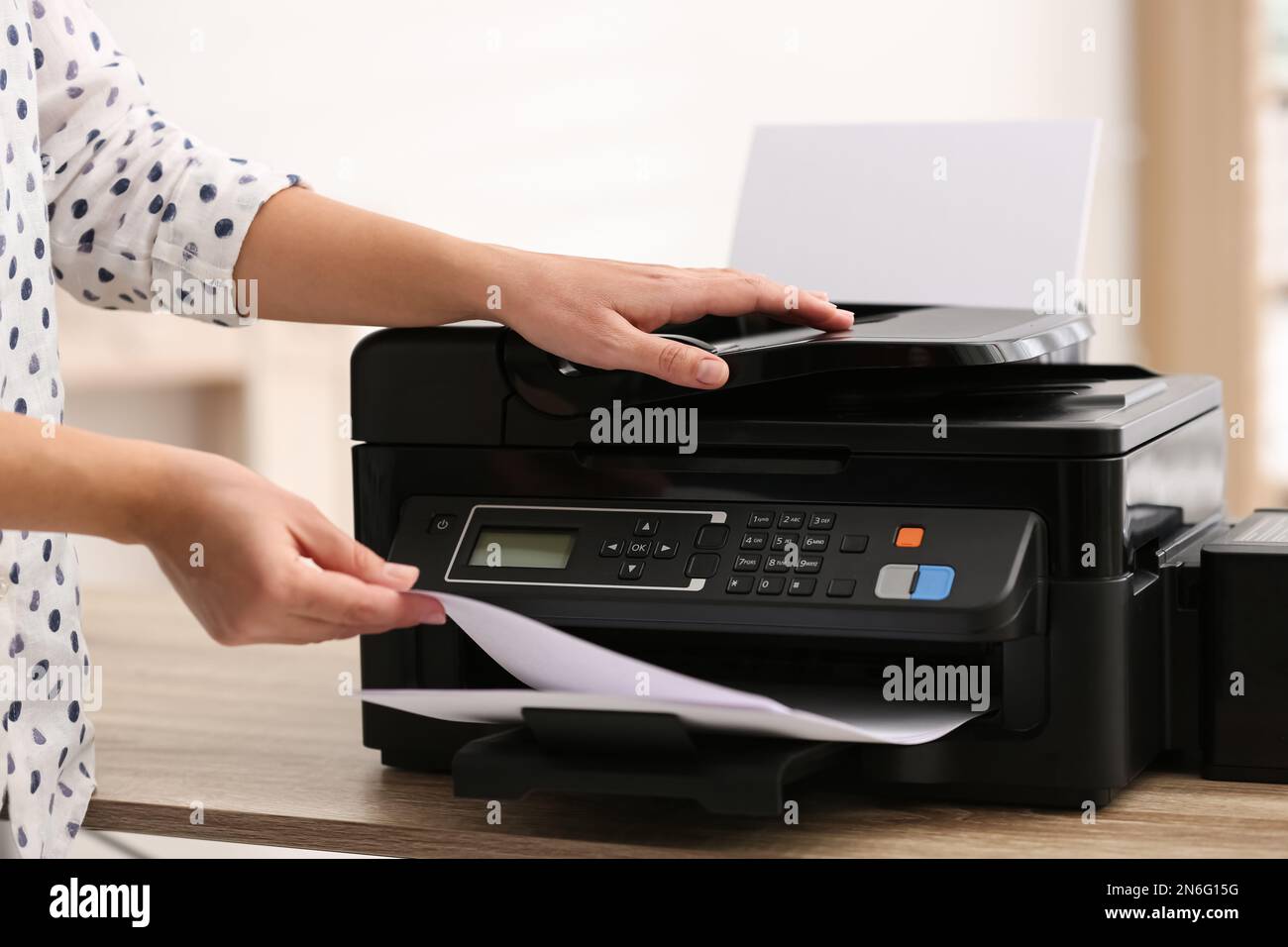 Employee using modern printer in office, closeup Stock Photo - Alamy
