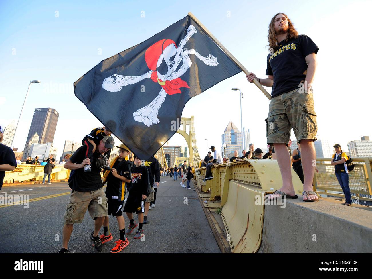 Derek Buck, of Pittsburgh, waves a Jolly Roger flag as he stands on the ...