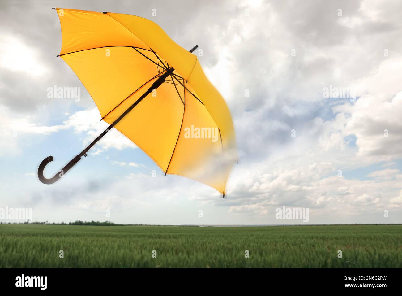 Open umbrella blown by wind gust outdoors Stock Photo - Alamy