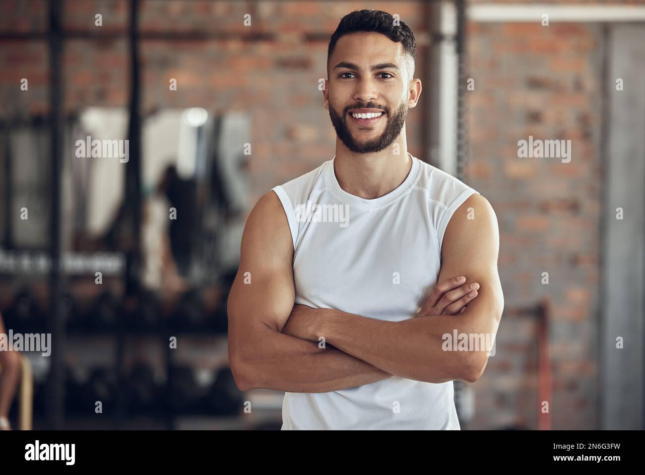 Portrait of a fit man arms crossed in the gym. Proud, muscular ...
