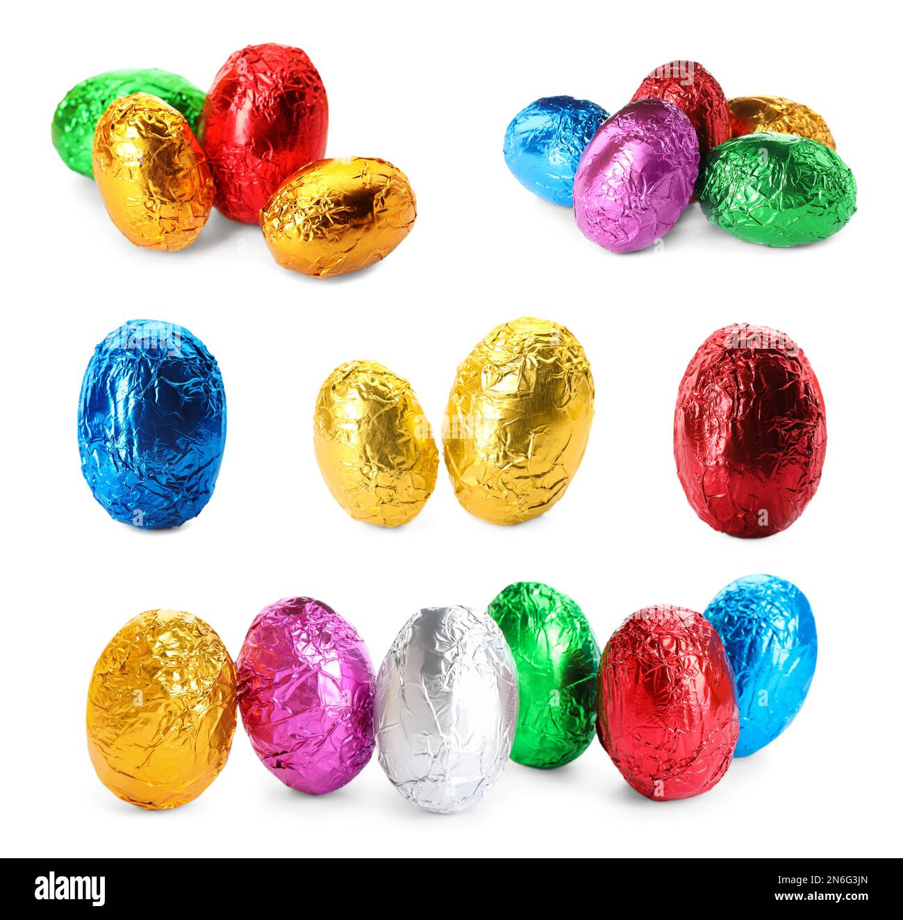 Set with chocolate eggs wrapped in bright foil on white background ...