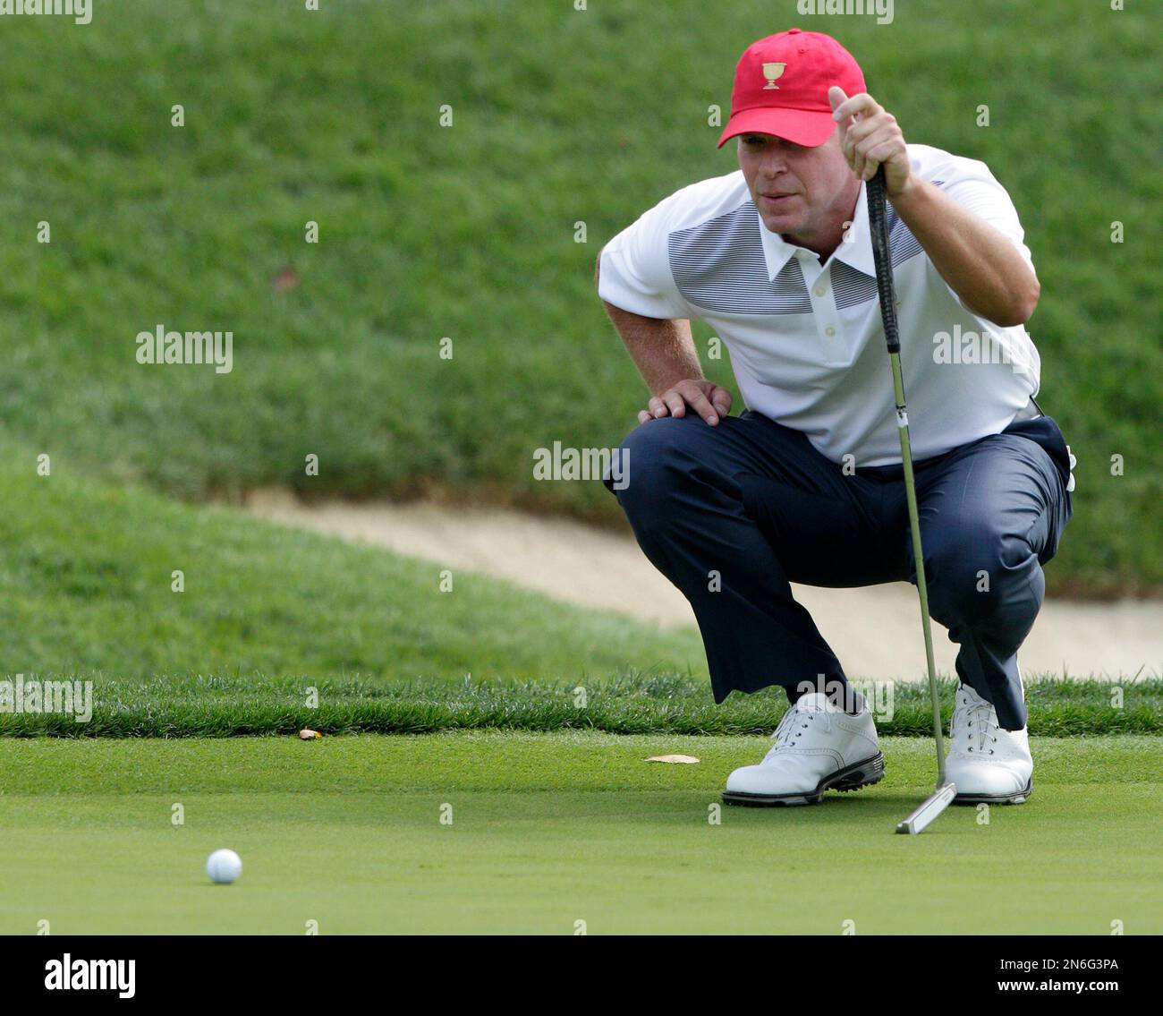 United States team player Steve Stricker lines up a putt on the 14th ...
