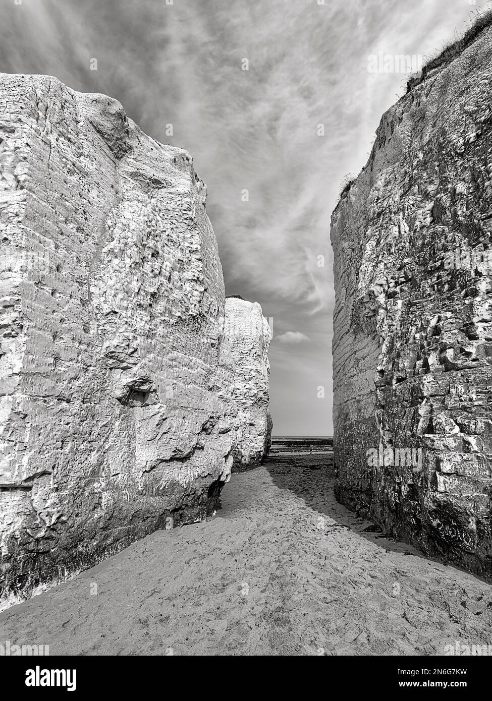 Chalk cliffs with passage to the sea, surf pillars and cliffs at low ...
