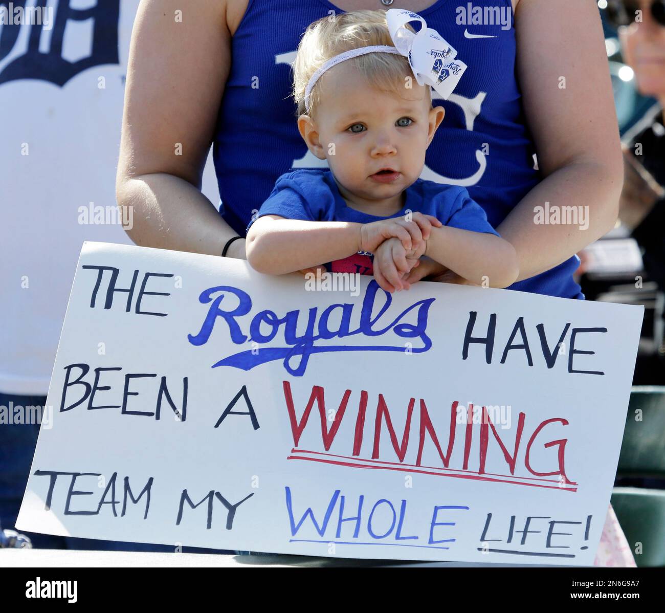 Kairi Robertson, from Indianapolis, holds a sign before a baseball game ...