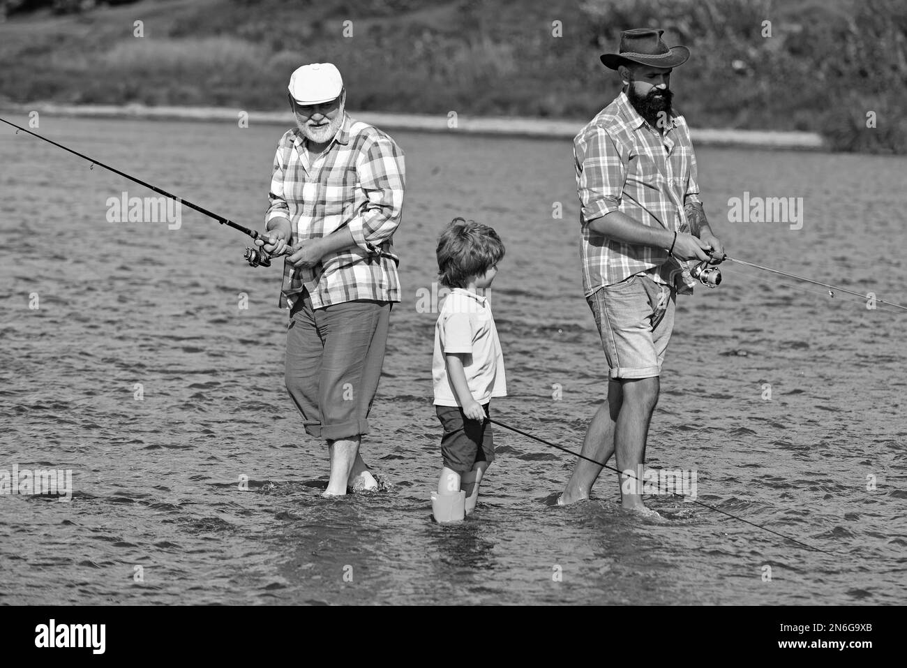 Fly fisherman using fly fishing rod in river. Family generation and ...