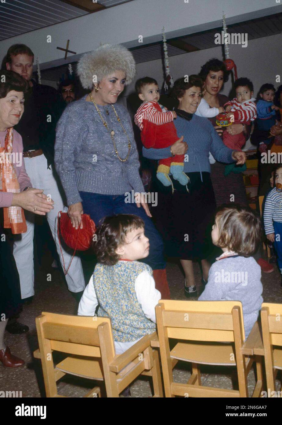 Actress Elizabeth Taylor, shown outside a poor area of Tel Aviv, Israel ...
