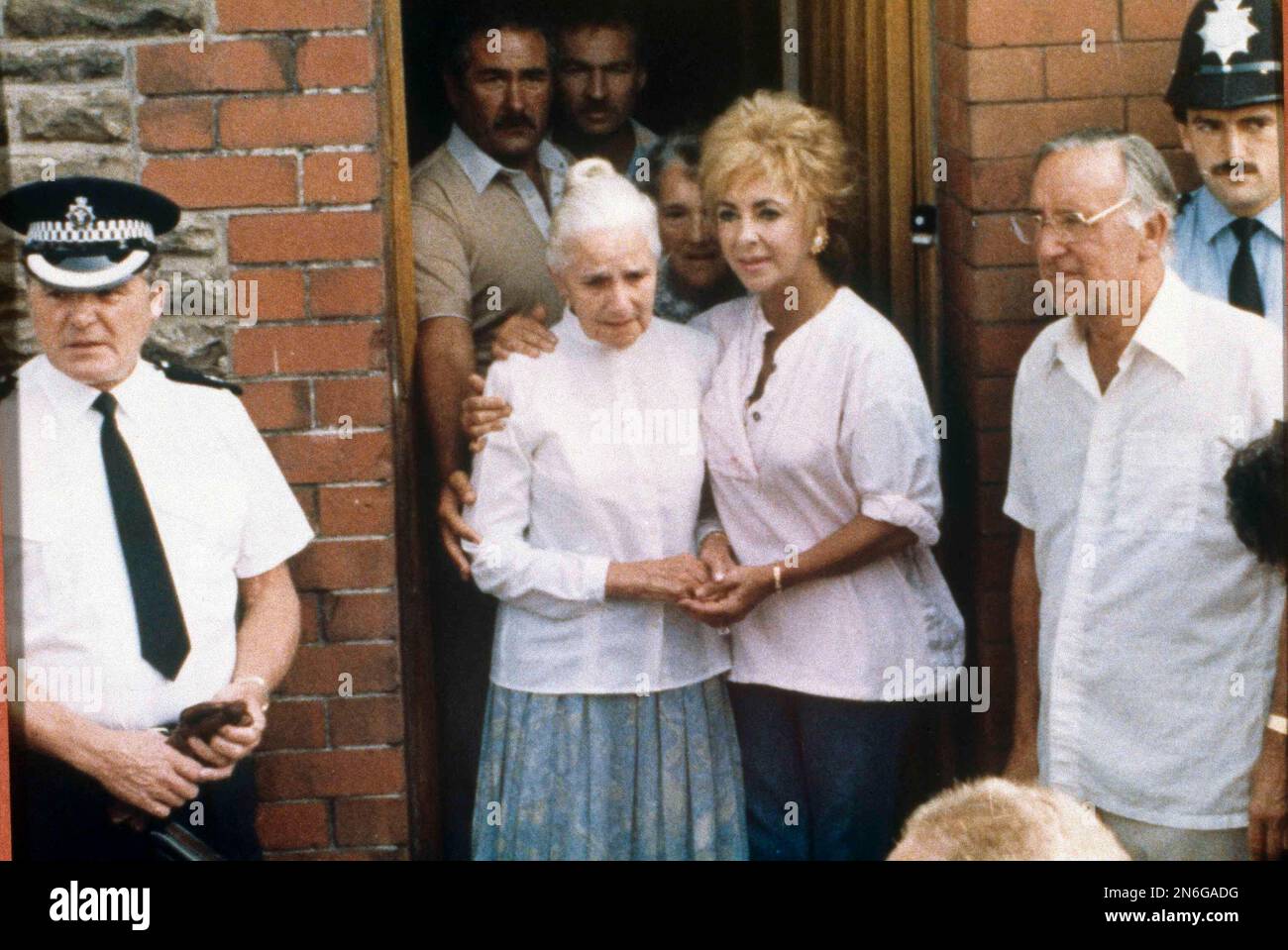 Actress Elizabeth Taylor holds the arm of 79-year-old Cecelia, sister of her late husband ...