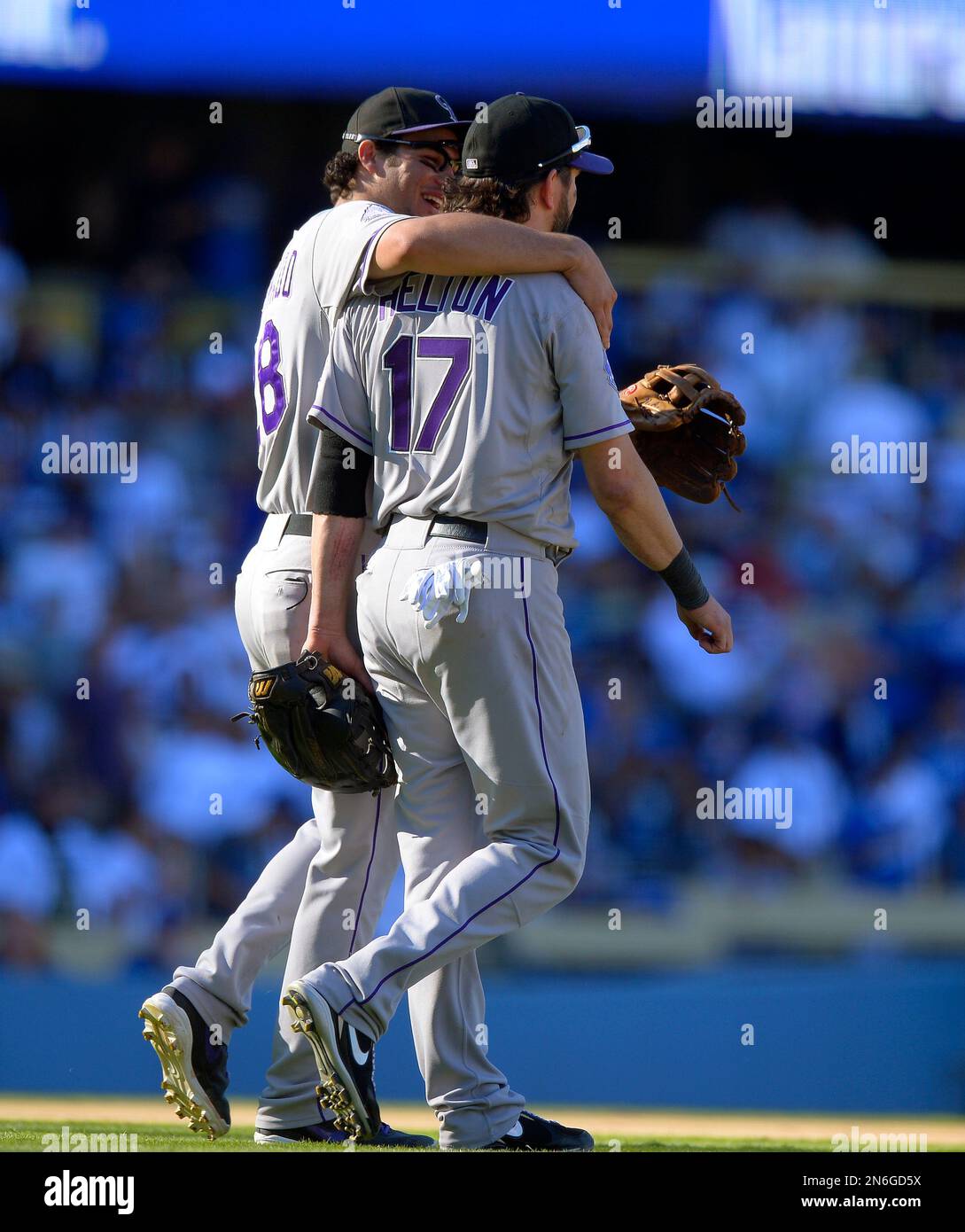Colorado Rockies' Nolan Arenado, left, hugs Todd Helton after the ...