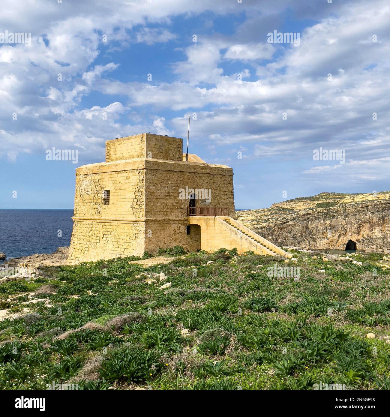 Dwejra Tower overlooking Dwejra Bay and inland sea, rock face with ...