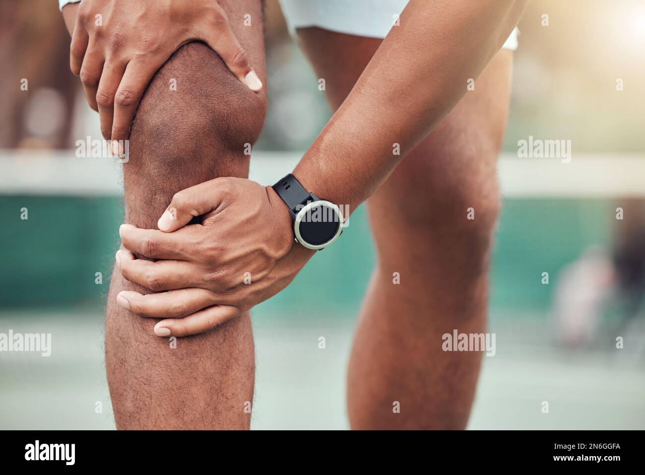Closeup of unknown indian tennis player suffering from knee injury in ...
