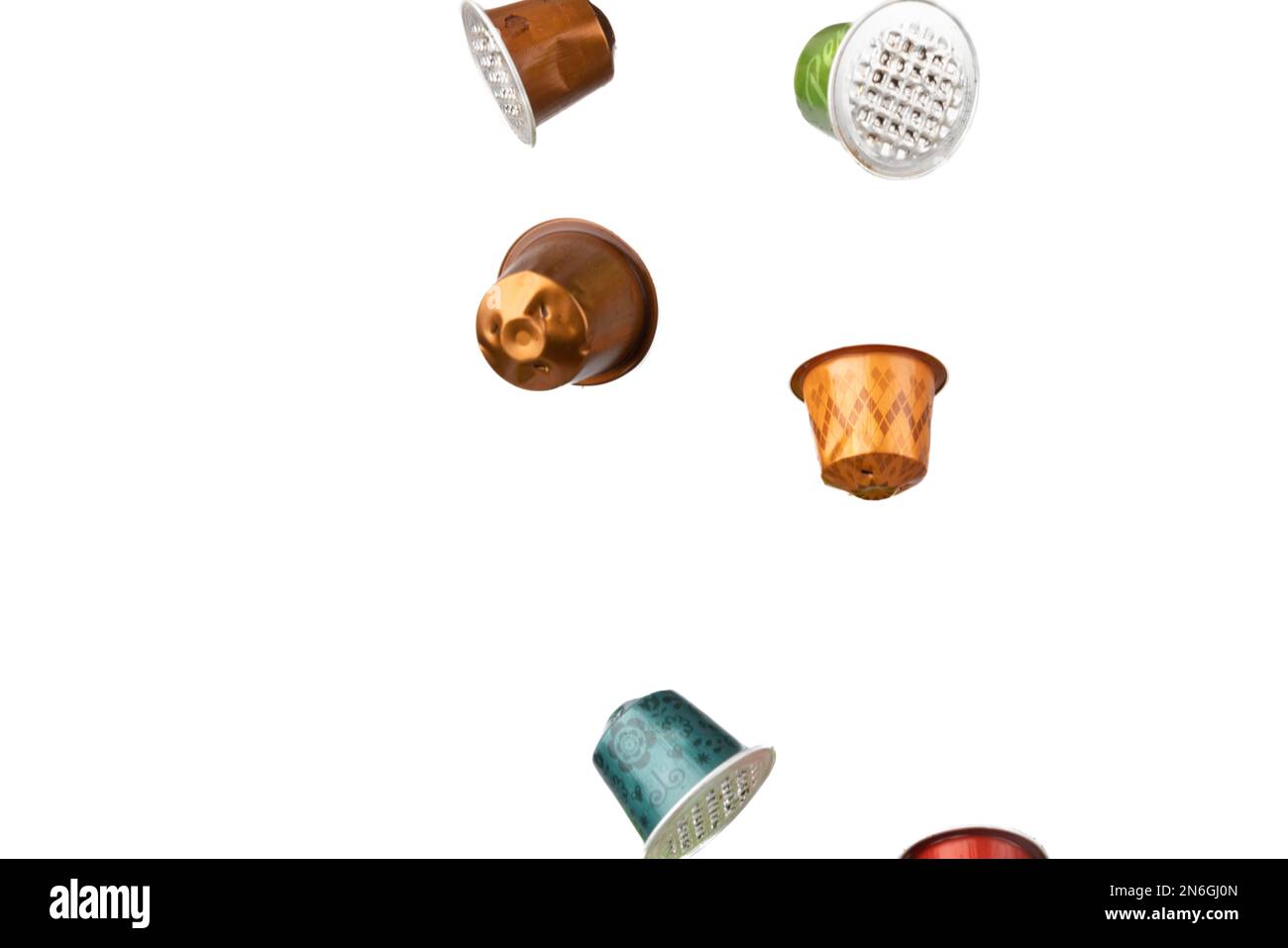 Different coloured used coffee capsules, flying, white background Stock ...