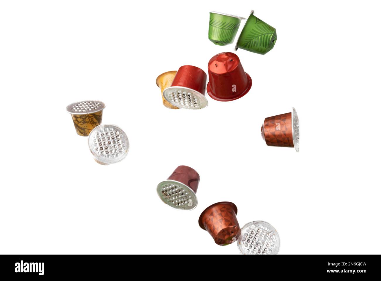 Different coloured used coffee capsules, flying, white background Stock ...