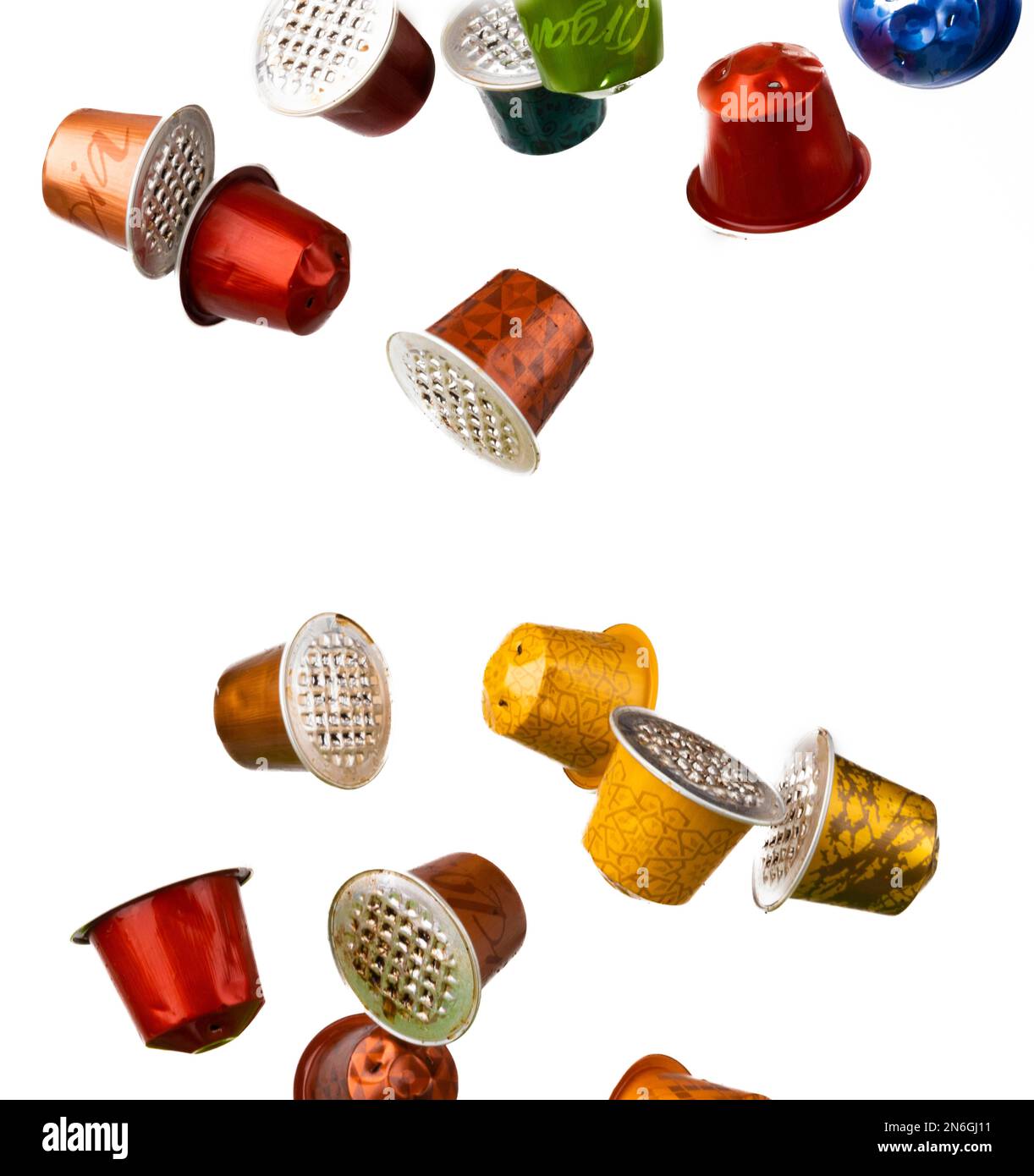 Different coloured used coffee capsules, flying, white background Stock ...