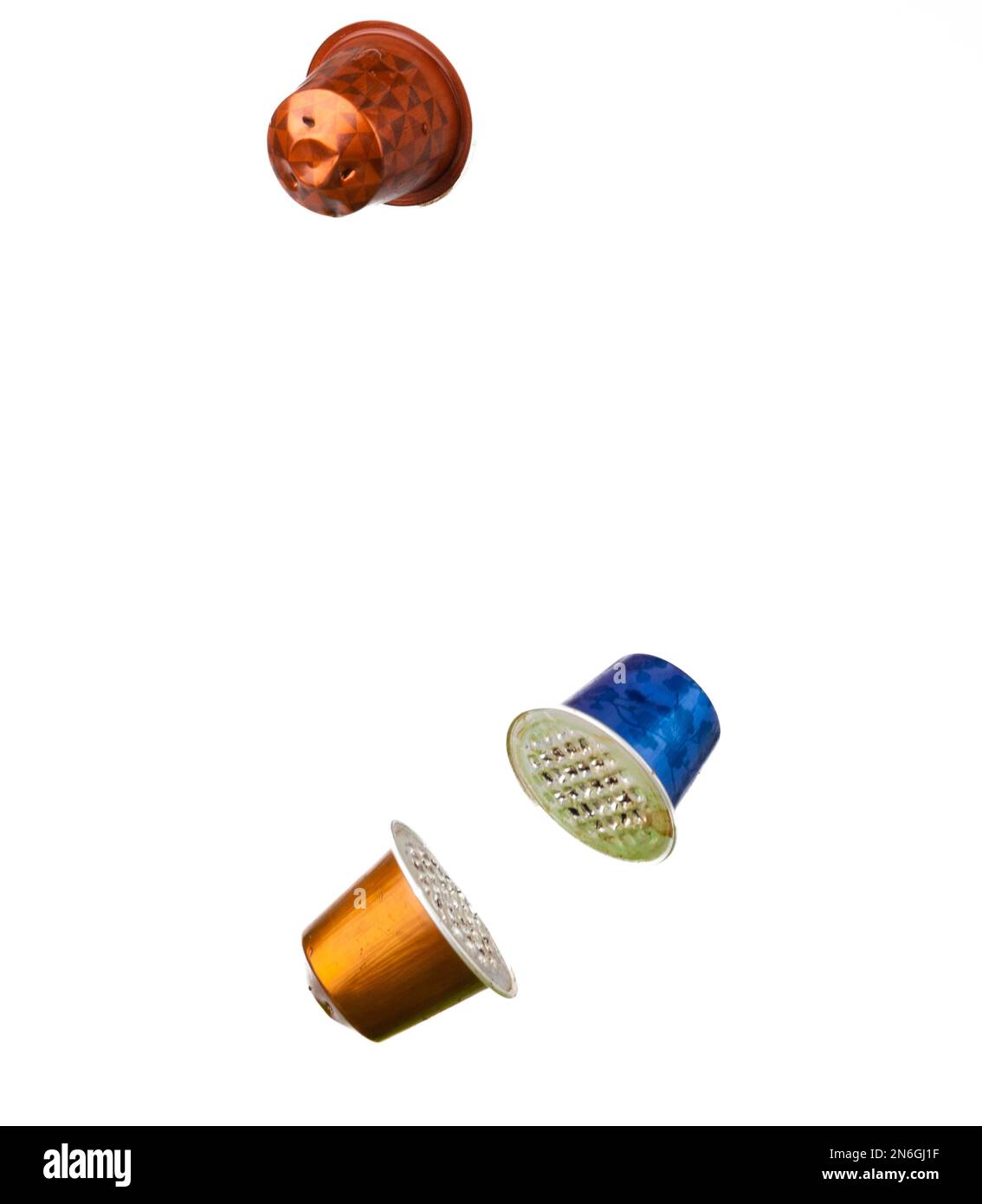 Different coloured used coffee capsules, flying, white background Stock ...