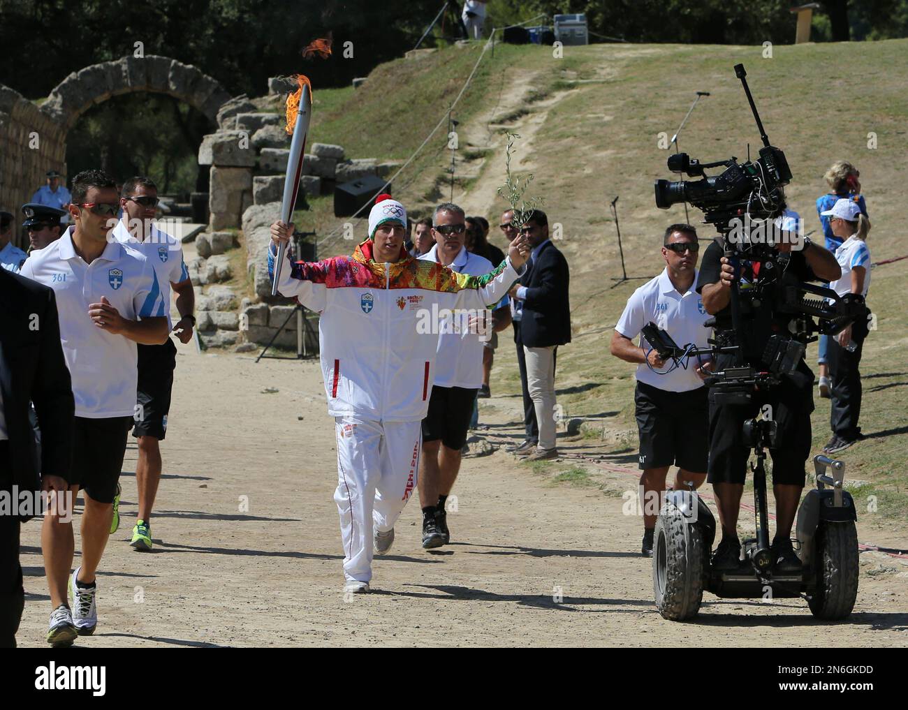 The first torch runner Greek champion skier Giannis Antoniou runs with ...