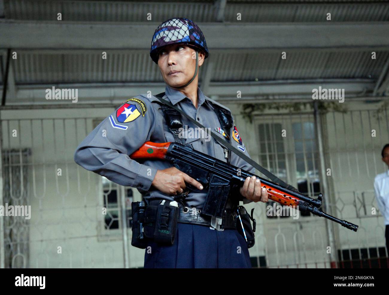 A Myanmar police officer provides security during a test run of a ...
