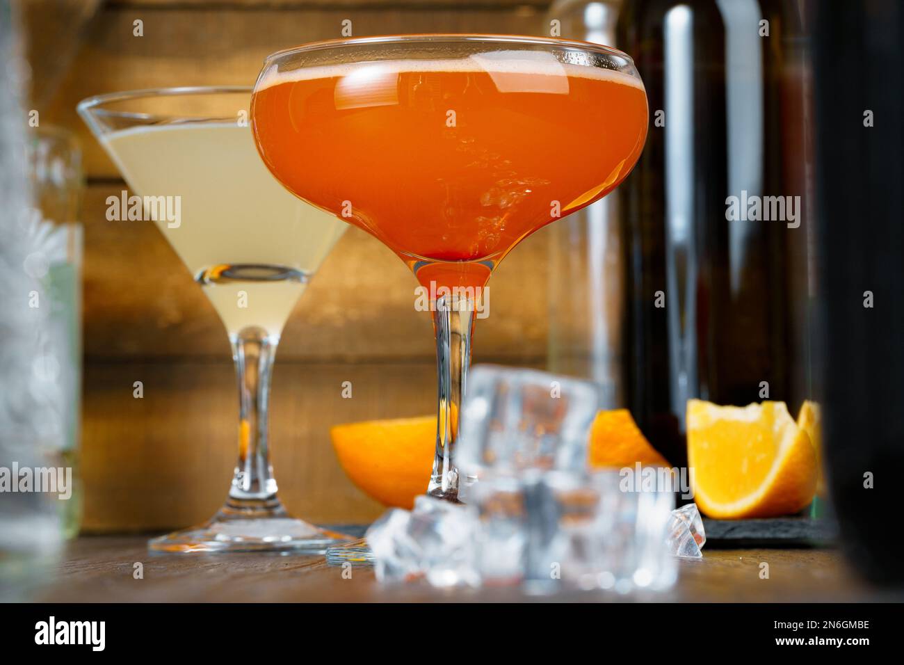 Two beautiful cocktails served on a wooden bar counter Stock Photo - Alamy