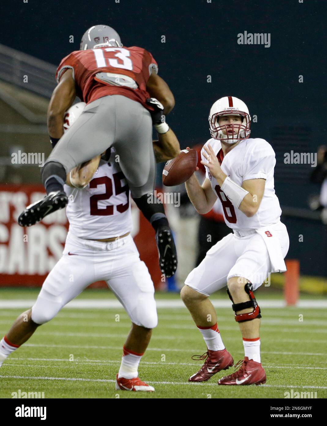 Stanford quarterback Kevin Hogan, right, looks to pass as Alex Carter ...