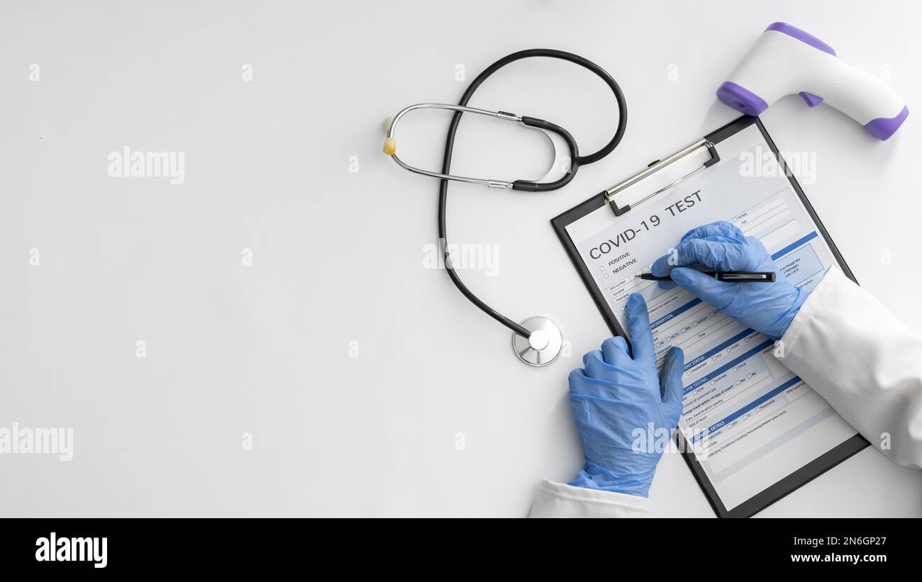 top view doctor completing covid form. Resolution and high quality ...