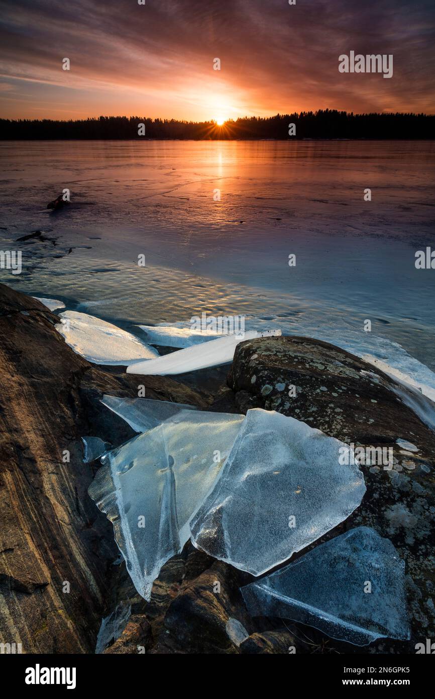 Ice formations and early morning winter sunrise by the lake Vansjø ...