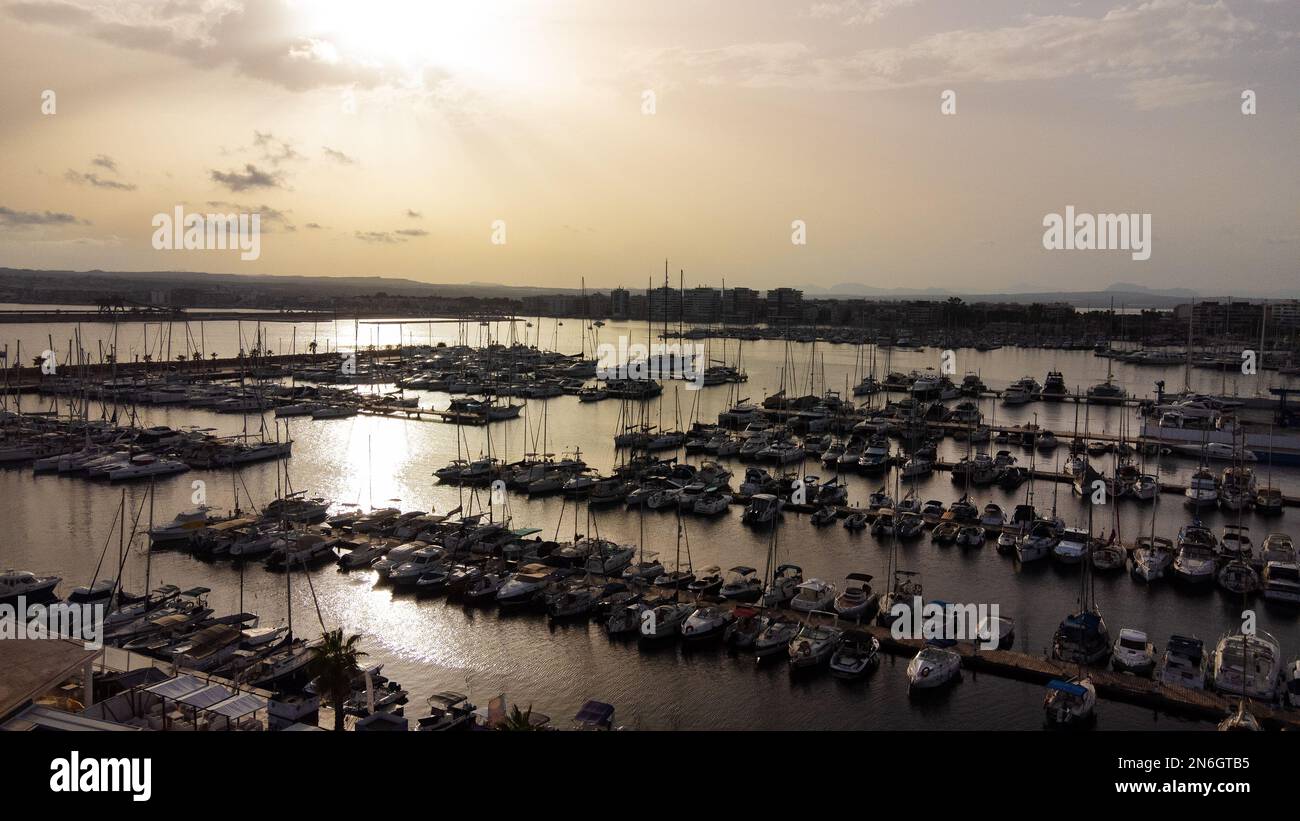 beautiful sunset over port with yachts and city of Torrevieja in Spain ...