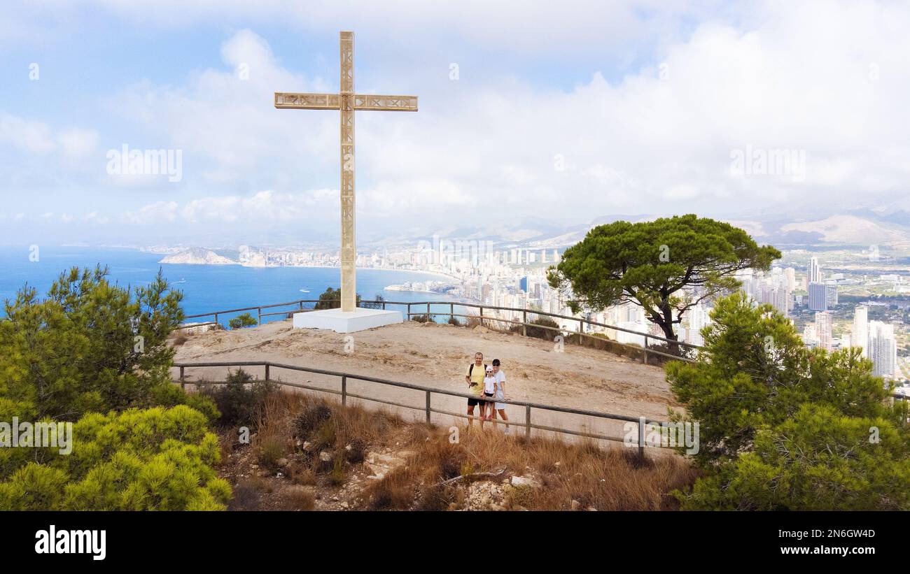 beautiful aerial view of family of tourists posing near cross La Cruz ...