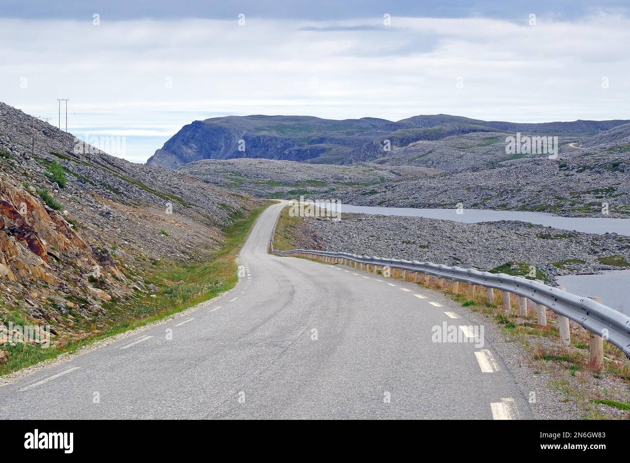 Road without traffic leads through barren, stony landscape, Mehamm ...