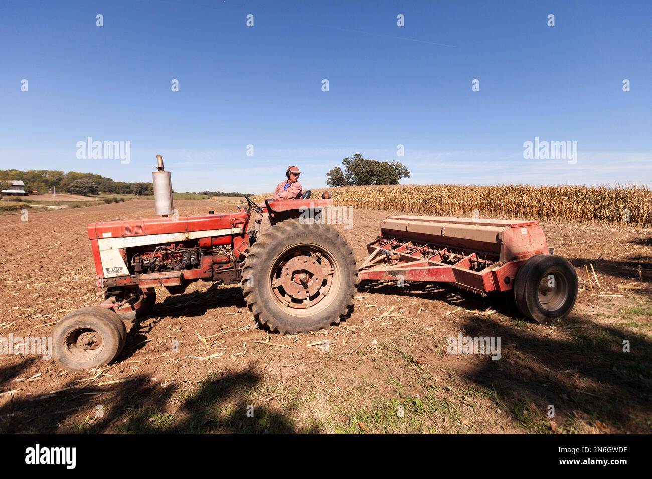 Tom Duerst drives his tractor planting winter wheat at his farm near ...