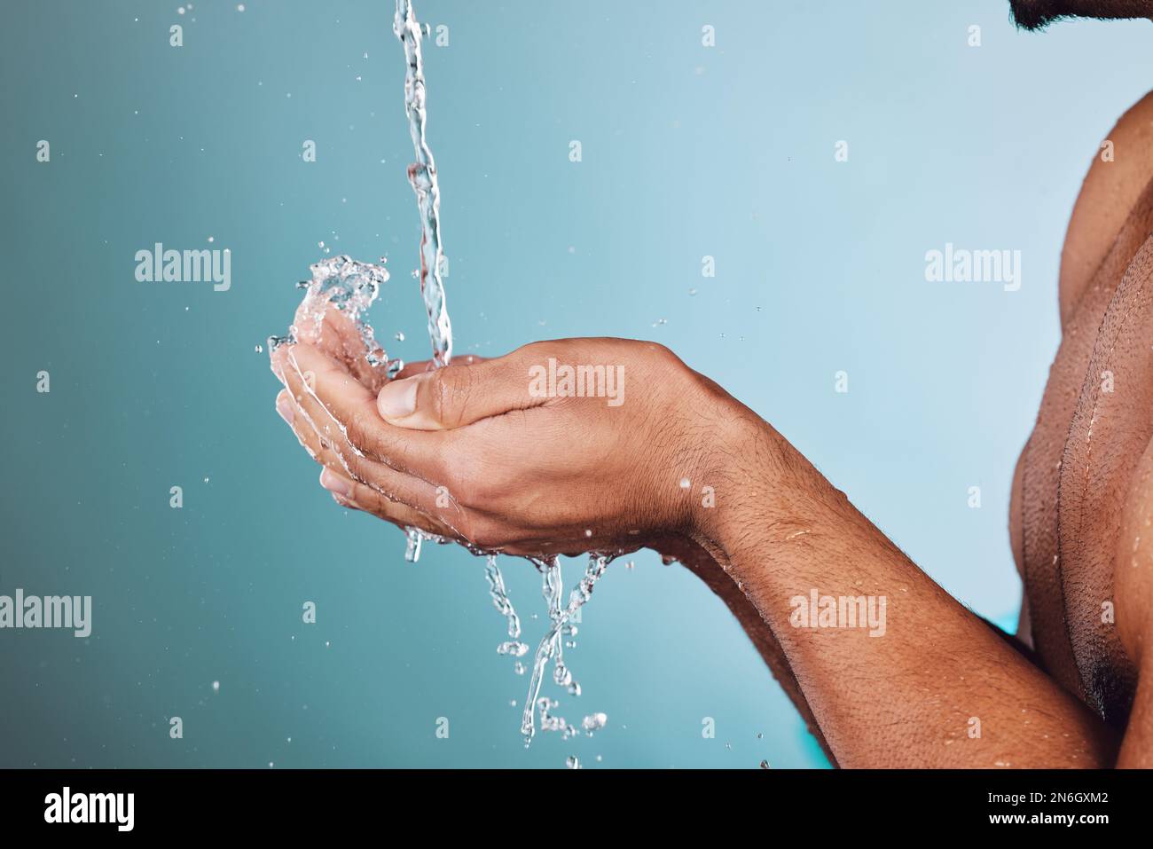Man, water splash and hands in shower for skincare hygiene, wash or ...