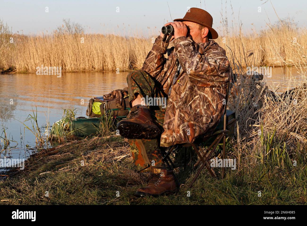Nature park photographer observes nature in camouflage clothing, Peene ...