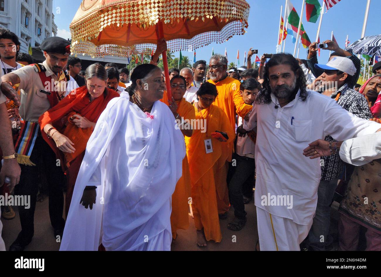 Indian spiritual leader Mata Amritanandamayi, left, arrives to attend ...