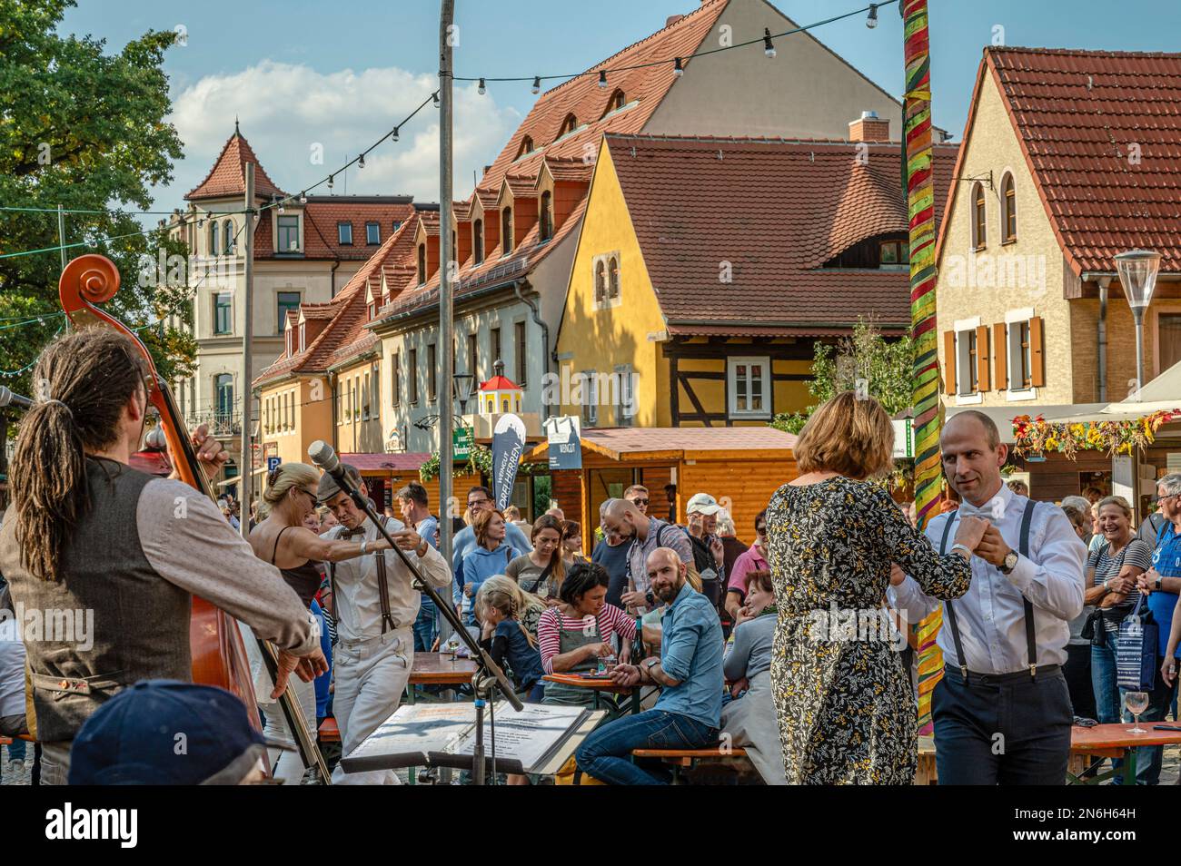 Happy people dancing during the Herbst und Weinfest Radebeul 2022 in ...