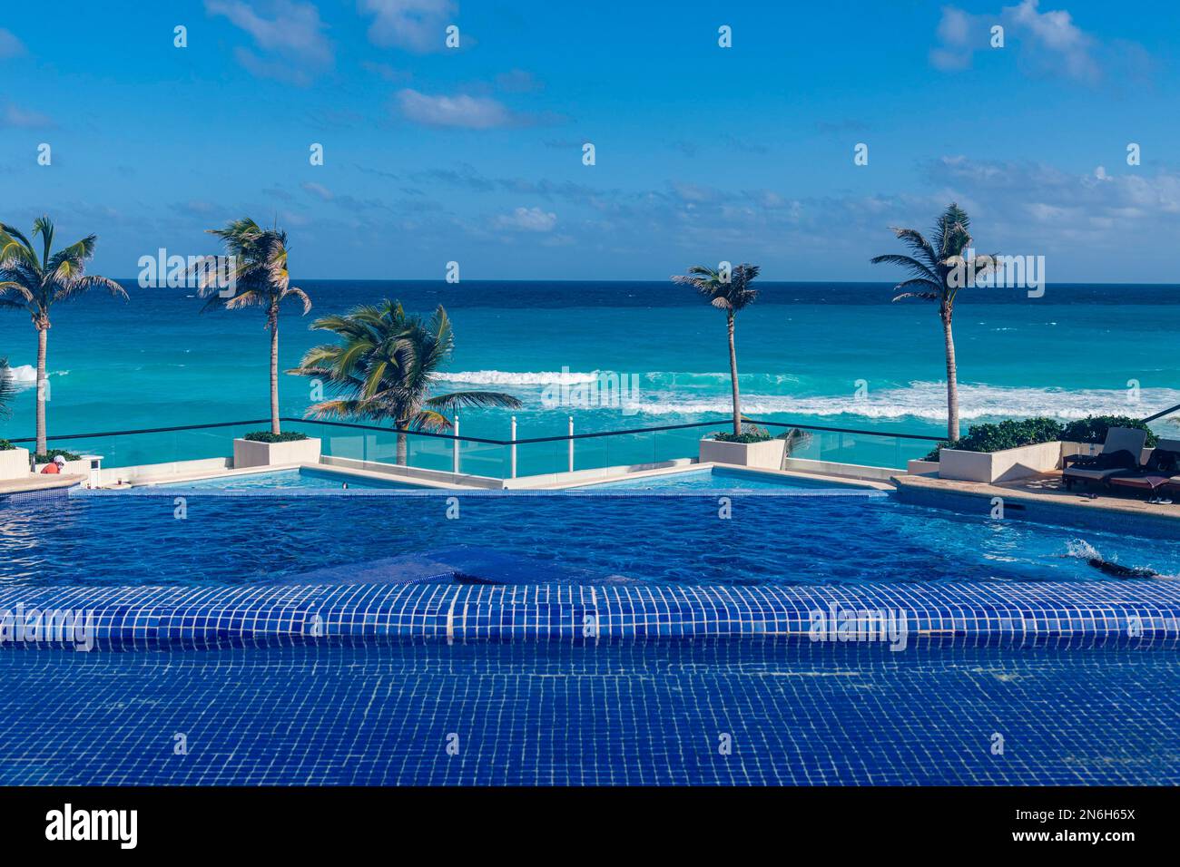 Swimming pool over the turquoise waters of Cancun, Quintana Roo, Mexico ...